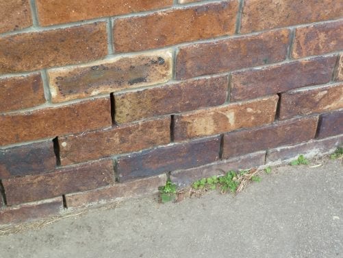 Salt damage to brick wall, cause and effects on buildings